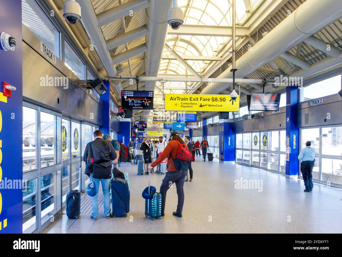 passengers Travelers wait for JFK AirTrain station serving airport ...