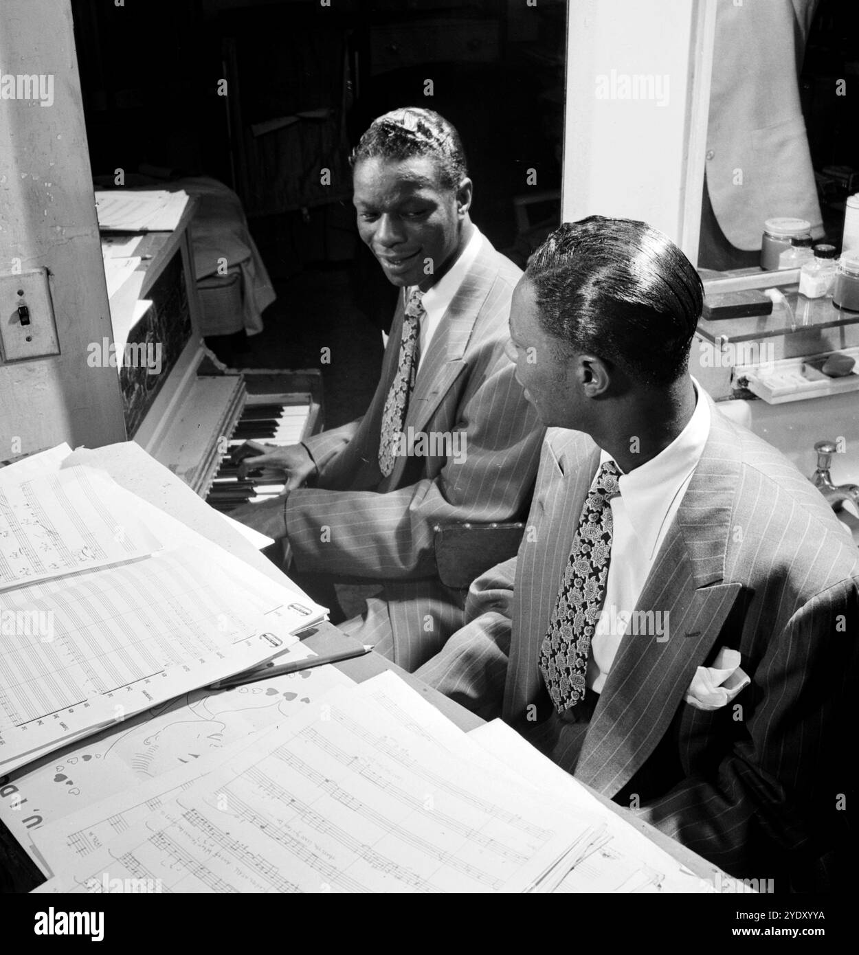 Portrait of Nat King Cole looking in a mirror, playing piano, New York ...