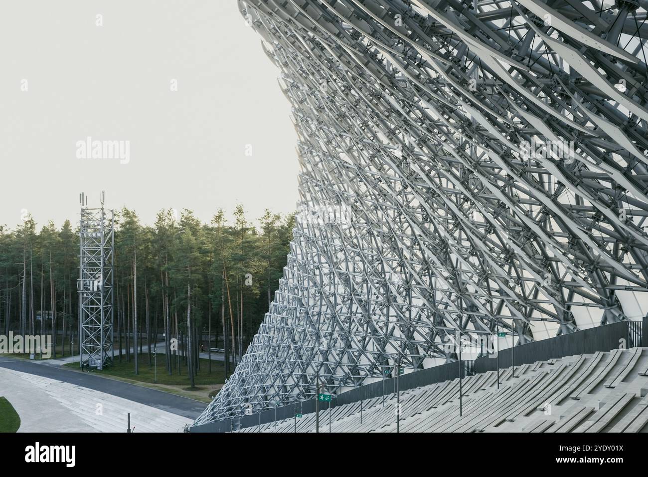 A striking architectural structure features a unique, curved framework ...