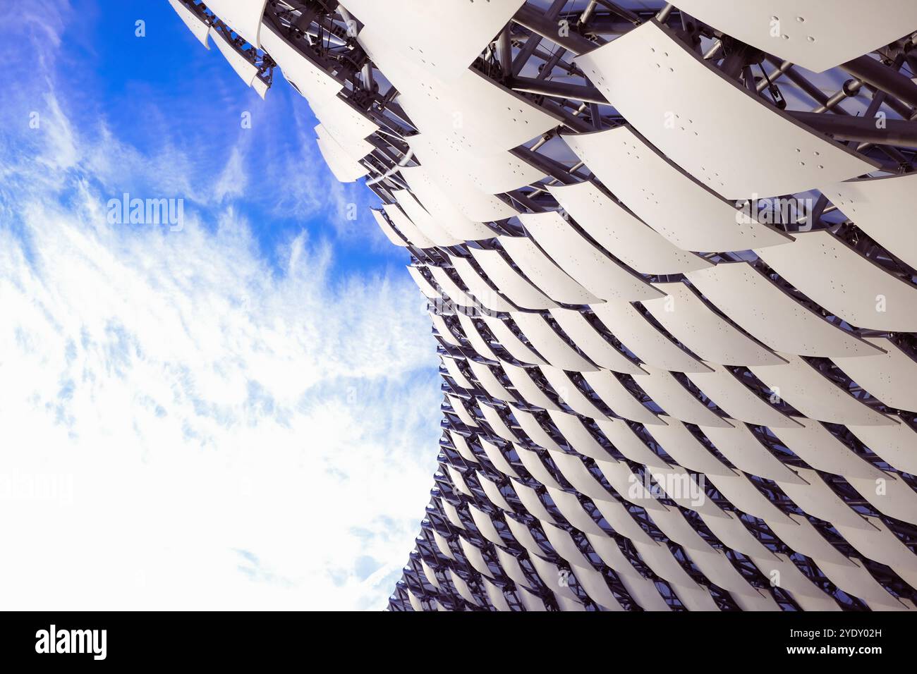 The striking architectural design features a dynamic, undulating ...