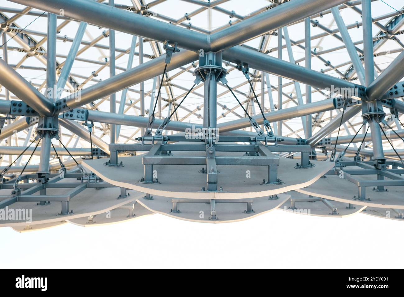 The underside of a large architectural canopy reveals a complex network ...