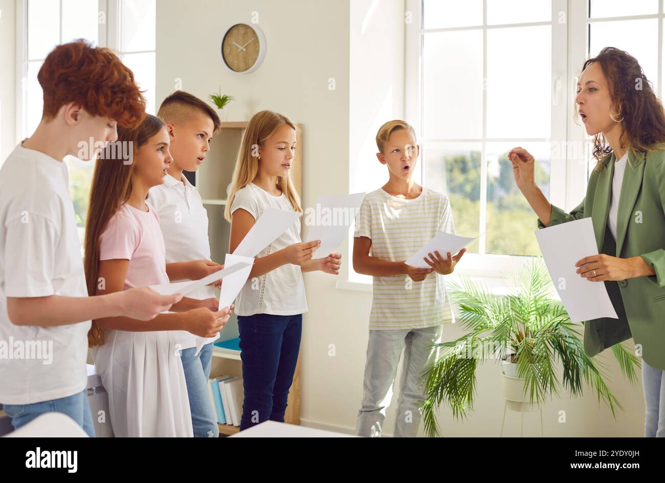 Teacher And Students Singing In School Music Class Stock Photo - Alamy