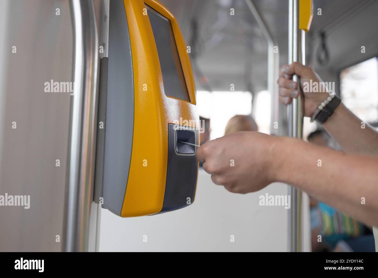 Yellow ticket validation machine on a modern public transport bus ...