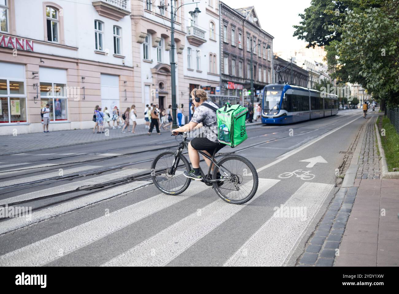Krakow, Poland - July 19, 2024. Uber Eats delivery driver on a bicycle ...