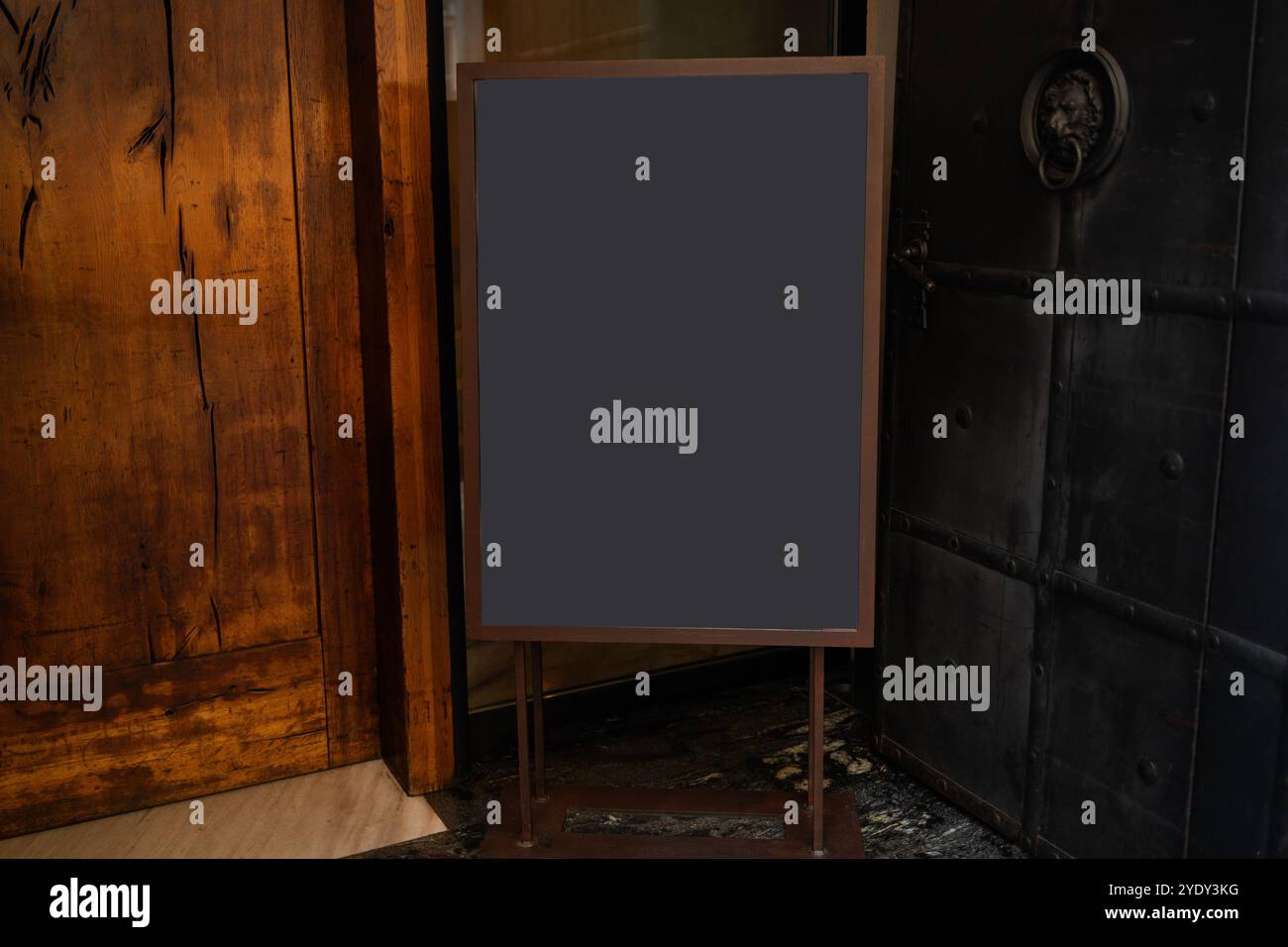 Black blank sheet is placed on located in front of a coffee shop. Blank ...