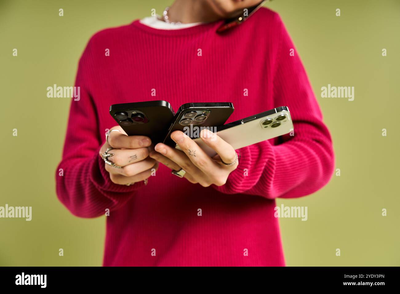 A fashionable young man showcases his charm while holding multiple ...