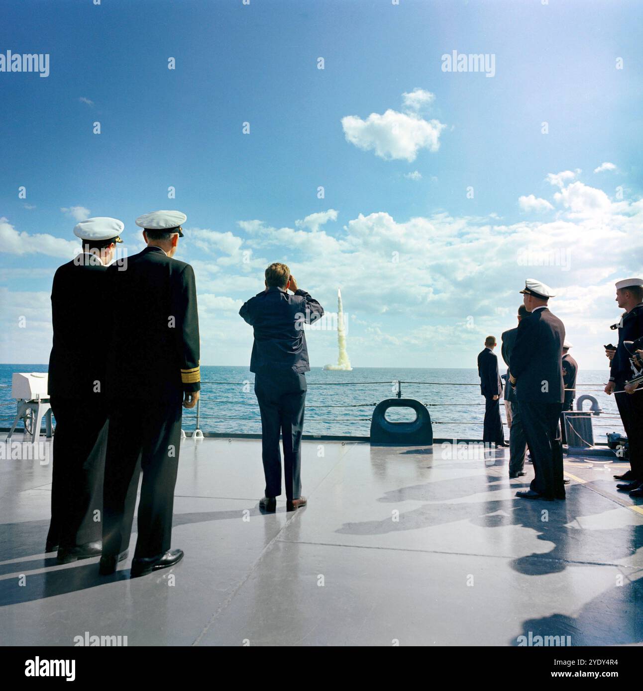 U.S. President John F. Kennedy (rear view, center left) aboard the U.S ...