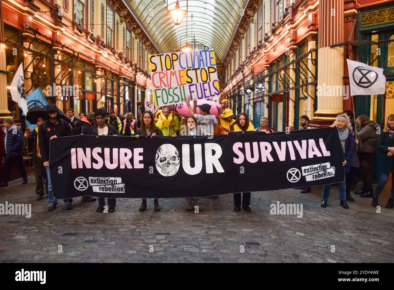 London, UK. 28th October 2024. Extinction Rebellion activists pass ...