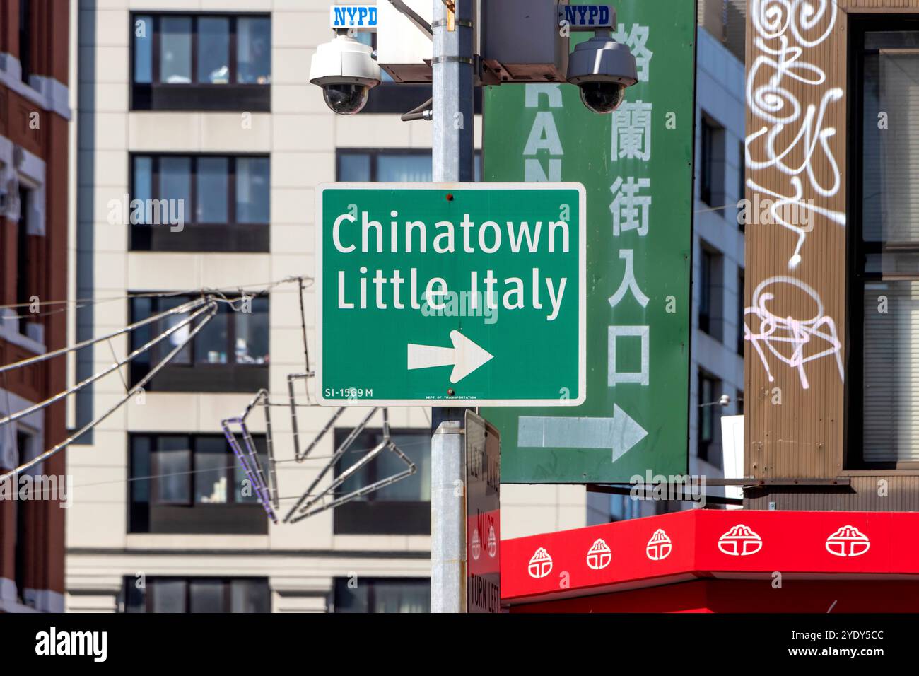 Street sign pointing towards Chinatown and Little Italy in a bustling ...