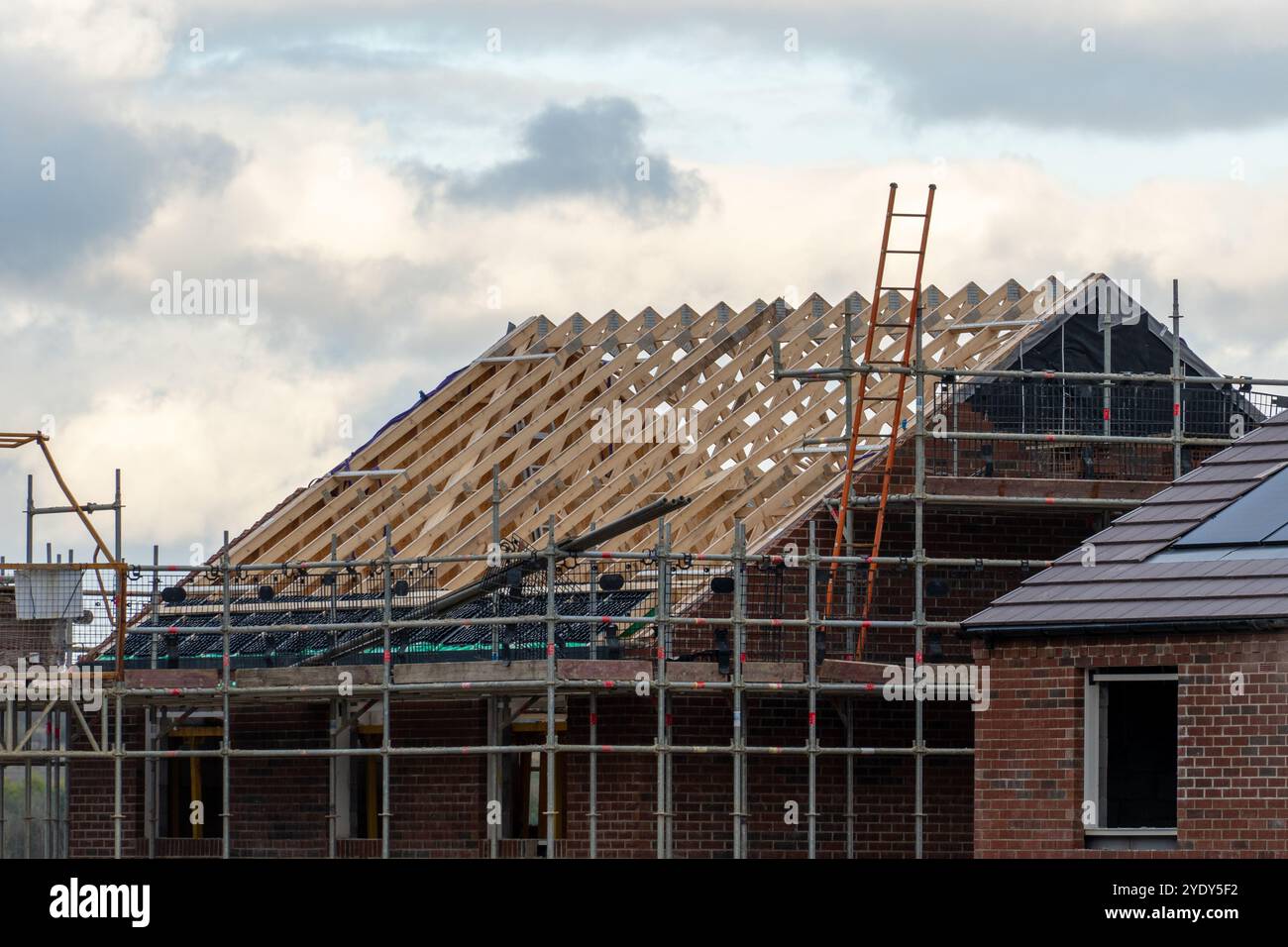 Roofing a property on a building site. New build housing in the suburbs ...