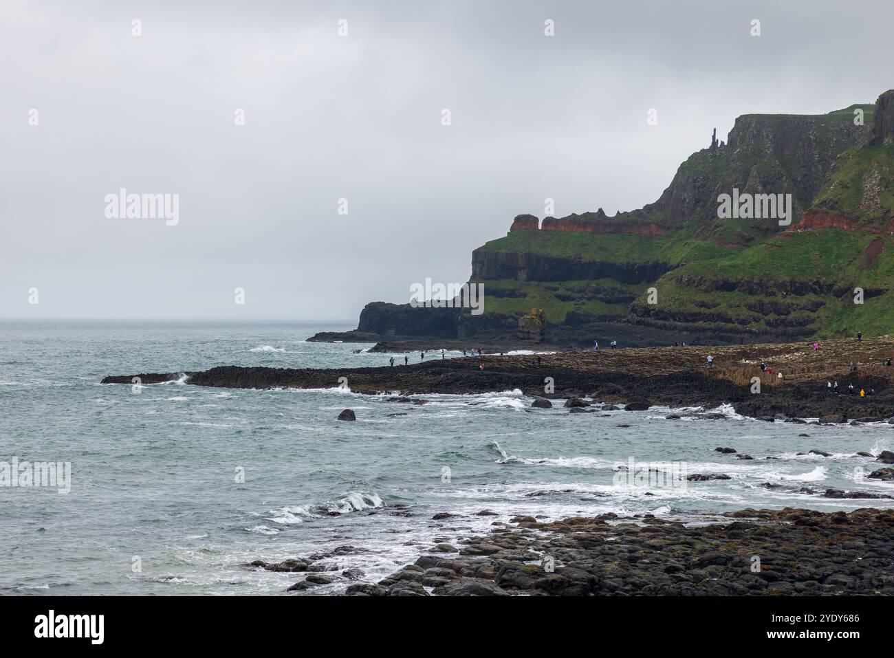 Giant's Causeway in Northern Ireland, filled with visitors admiring the ...
