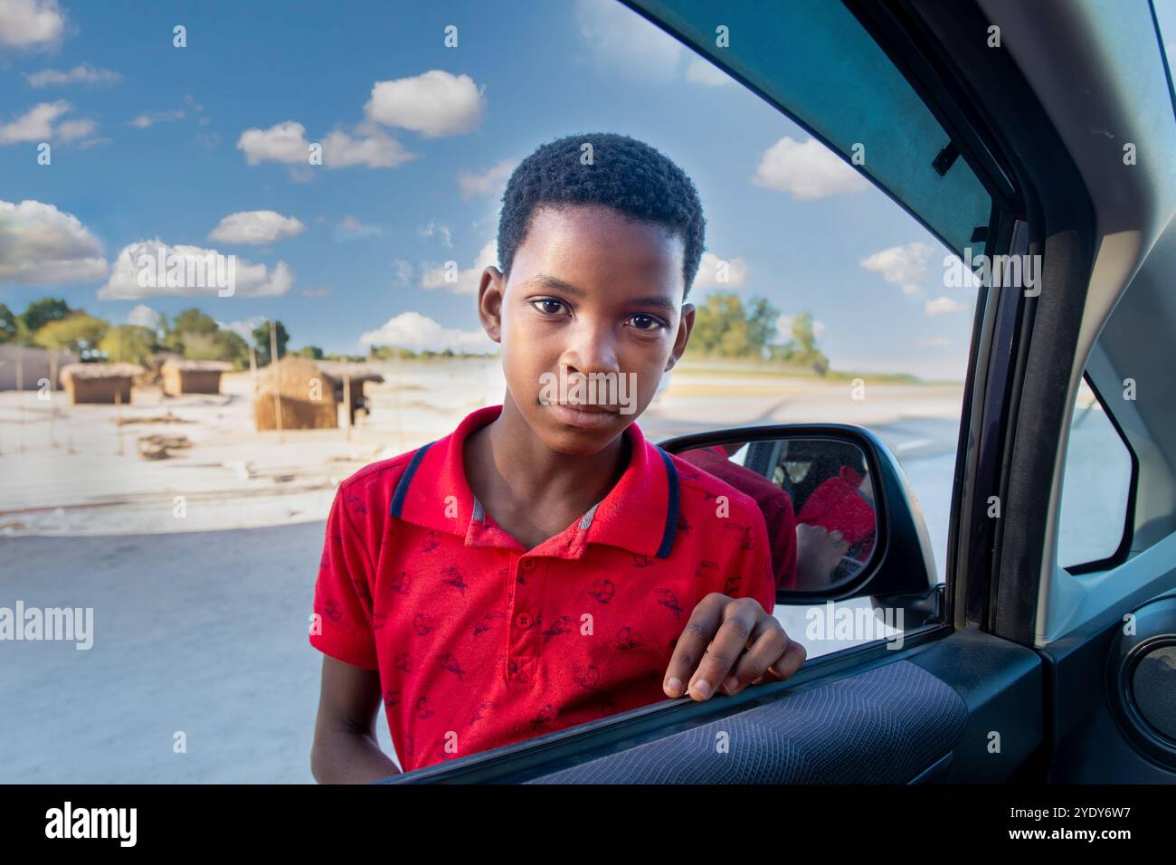 village african child waiting by the car window asking for directions ...
