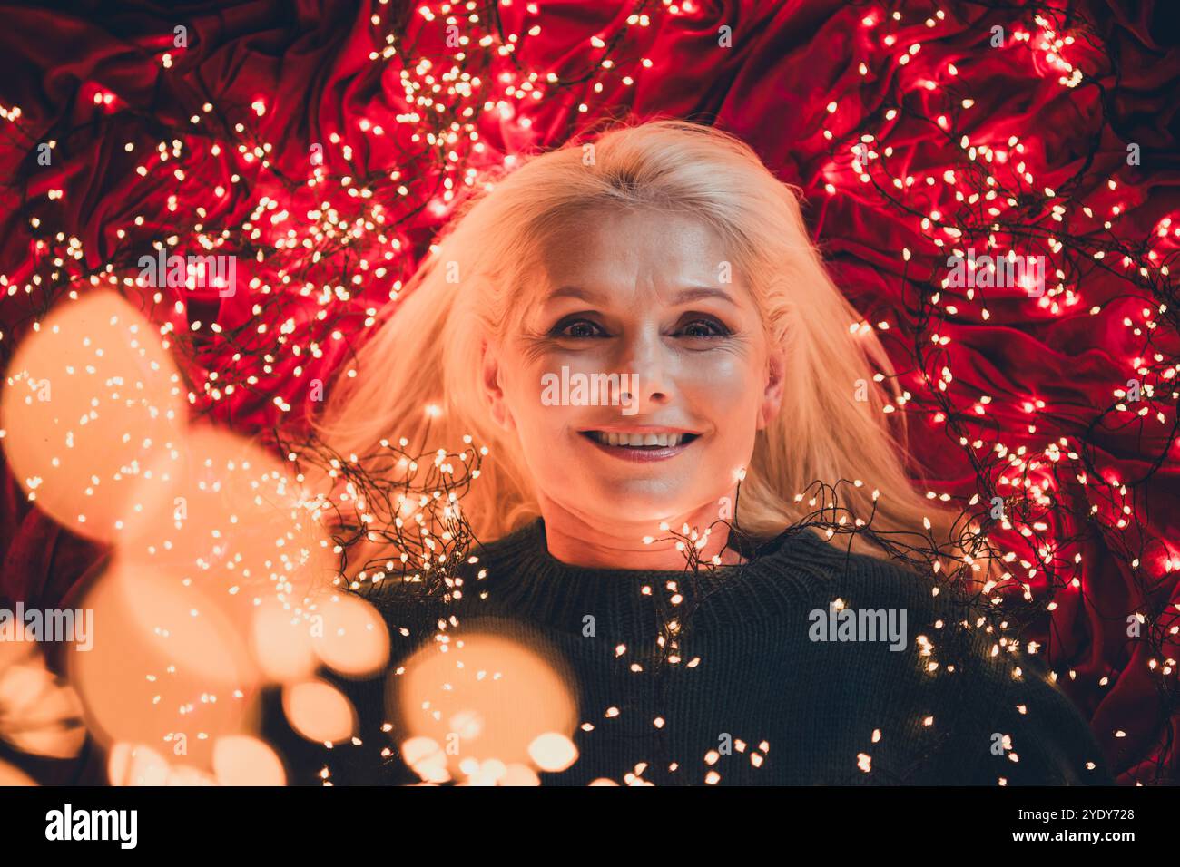 Photo of lovely pensioner lady lying floor garland lights dressed ...