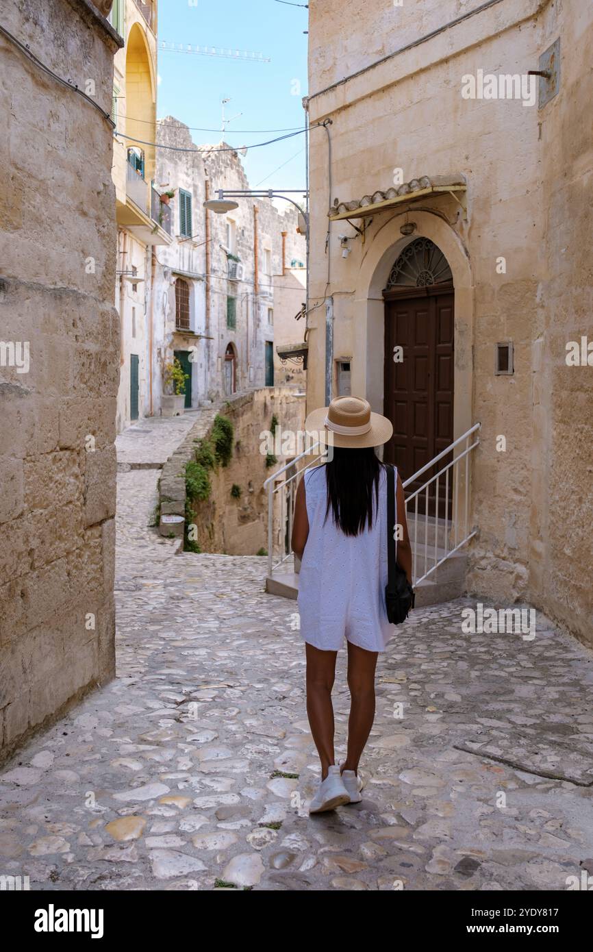 Wandering through the narrow cobblestone streets of Matera, a traveler ...