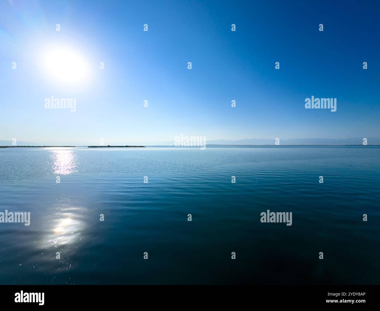 A horizontal line of water and sky with a smooth transition of colors ...