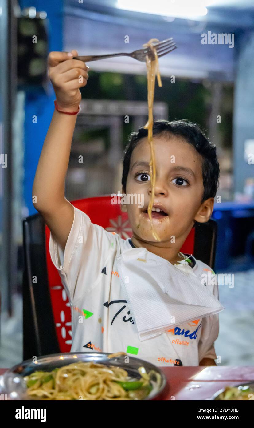 Child eating hakka noodles indoors hi-res stock photography and images ...
