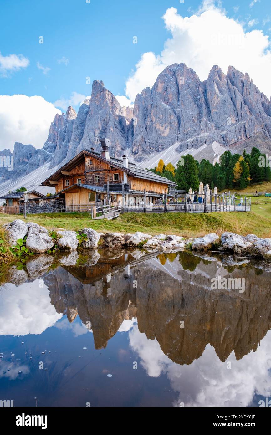 Amidst the stunning Dolomite mountains, a charming wooden chalet rests ...