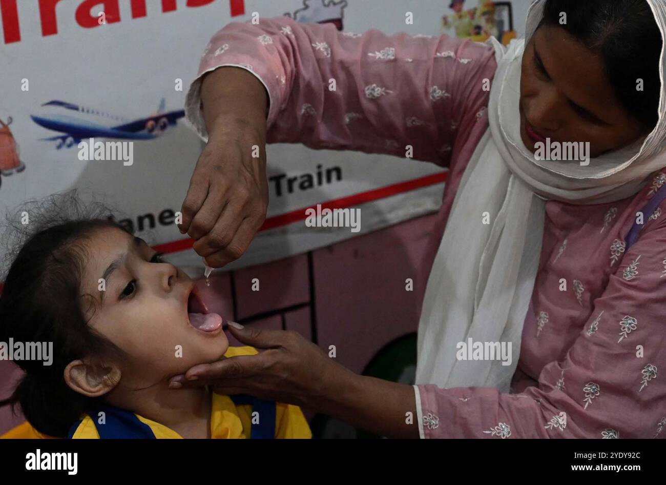 Health worker administrates polio-vaccine drops to a child during anti ...