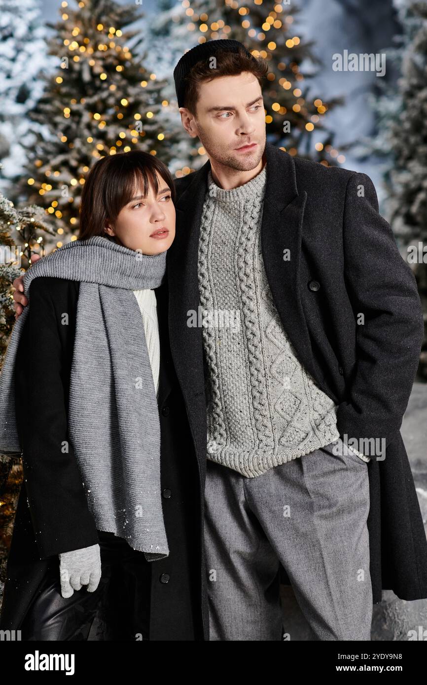 A loving couple stands close, wrapped in warmth amidst the snowy pines ...