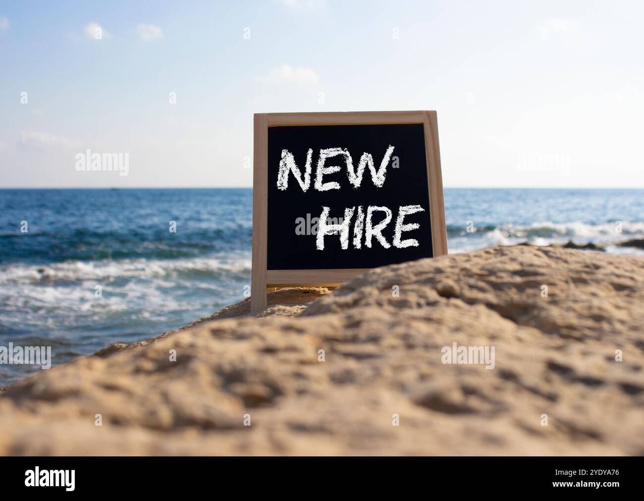 New Hire symbol. Concept words New Hire on black chalk background ...