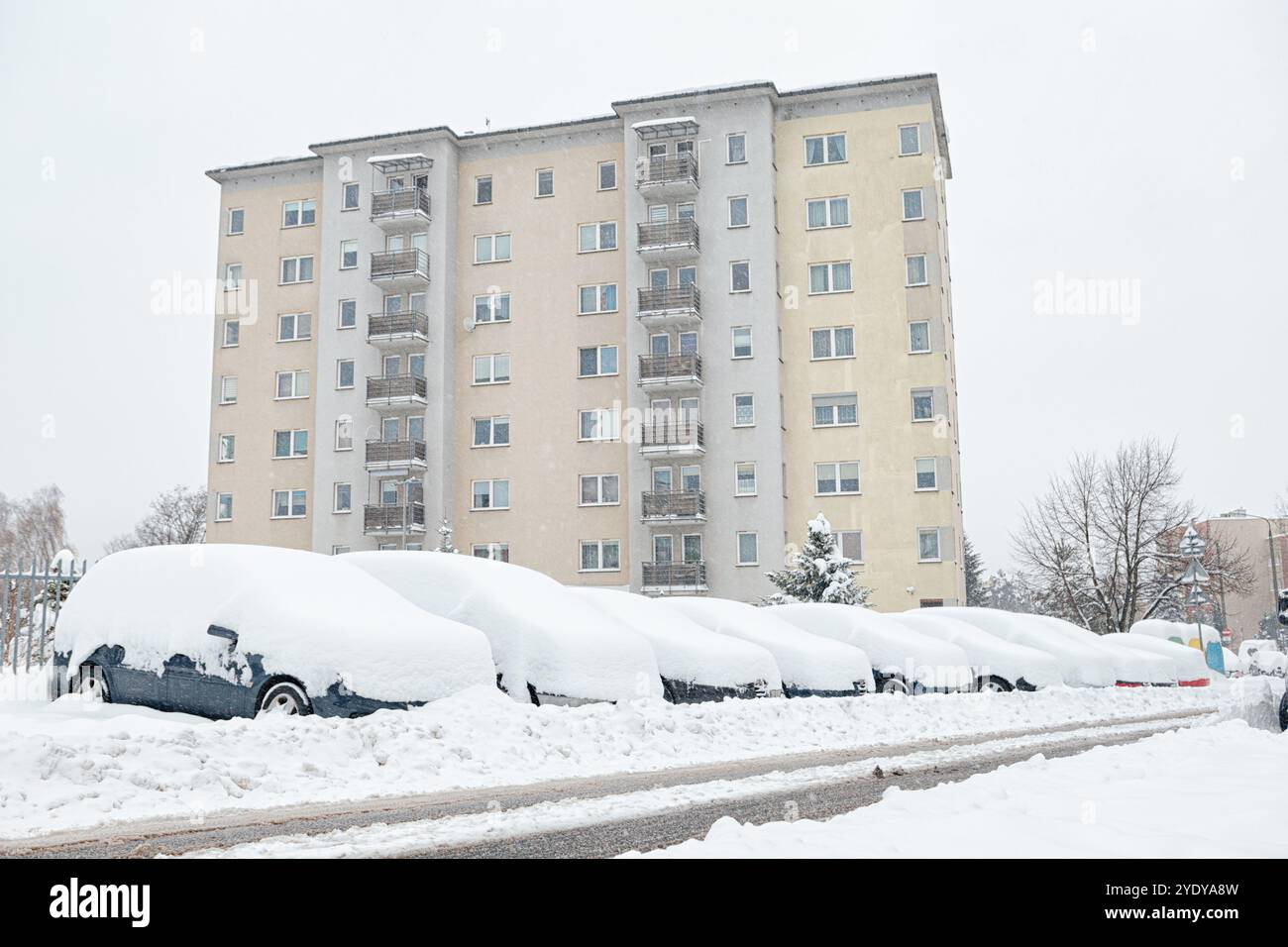 A street in Krakow is covered with snow after a blizzard in winter. Car ...