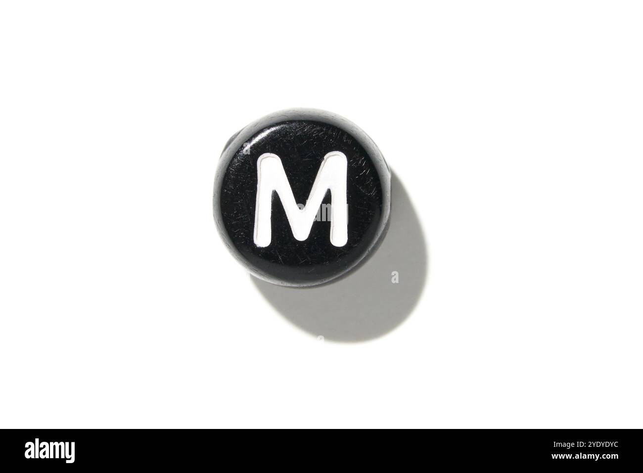 Black keyboard key with letter m isolated on white background with ...