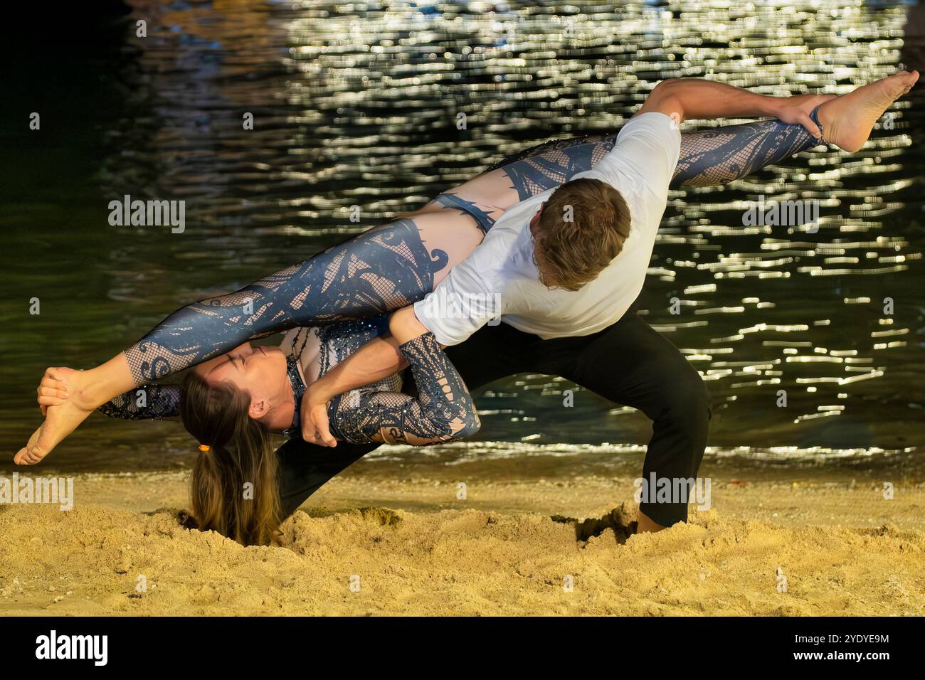 A couple performs an elegant gymnastic pose at Qatar's Katara Fan Zone ...