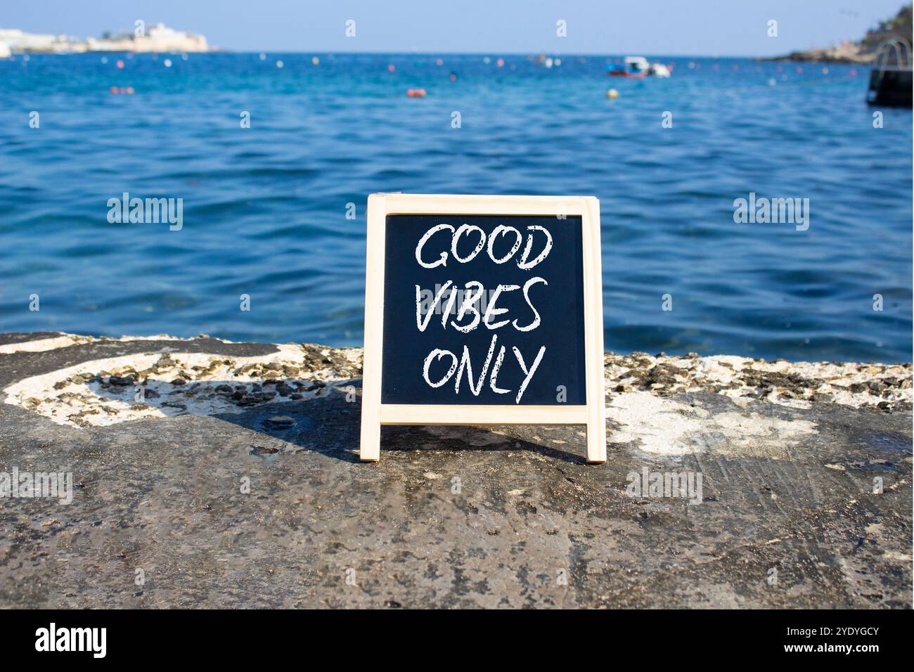 Good Vibes only symbol. Blackboard with Concept words Good Vibes only. Beautiful sea background ...