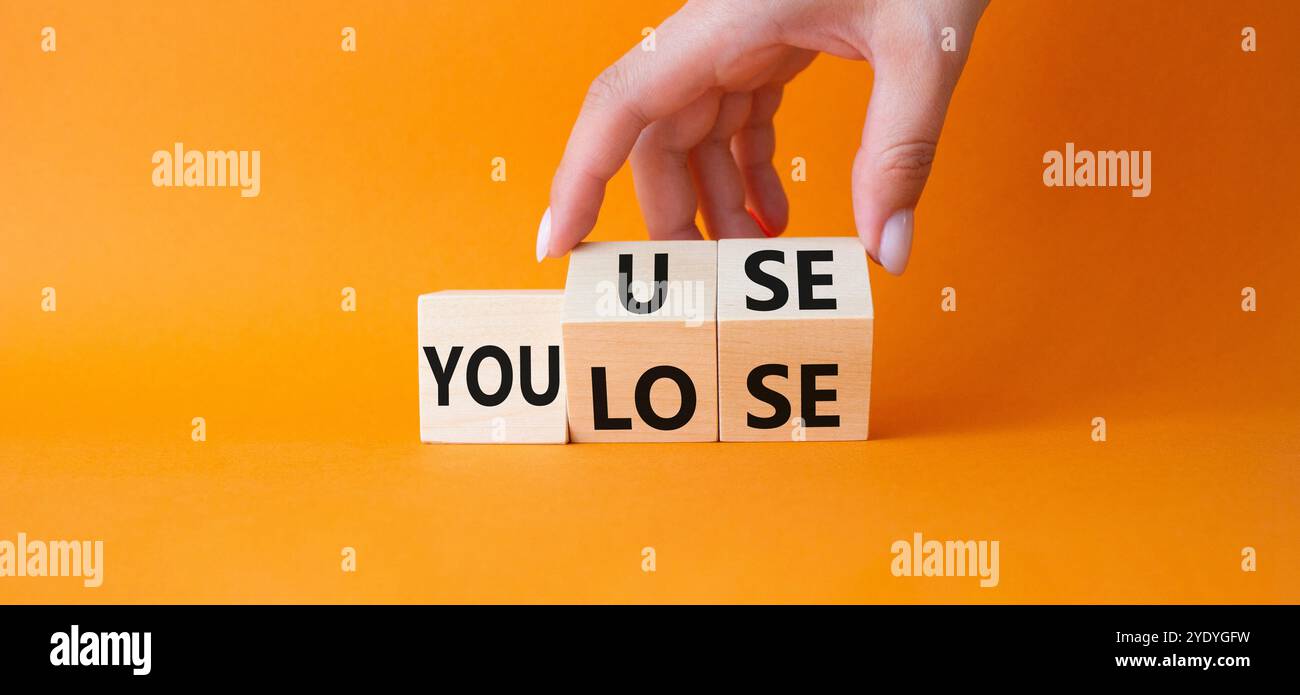 You use or lose symbol. Businessman hand Turns cube and changes word ...