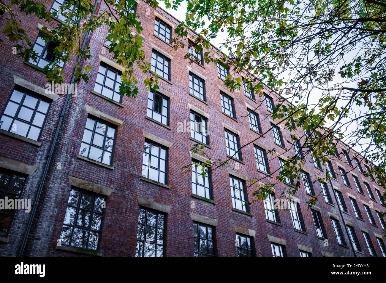 Brick mill building facade converted to apartments in Manchester city ...