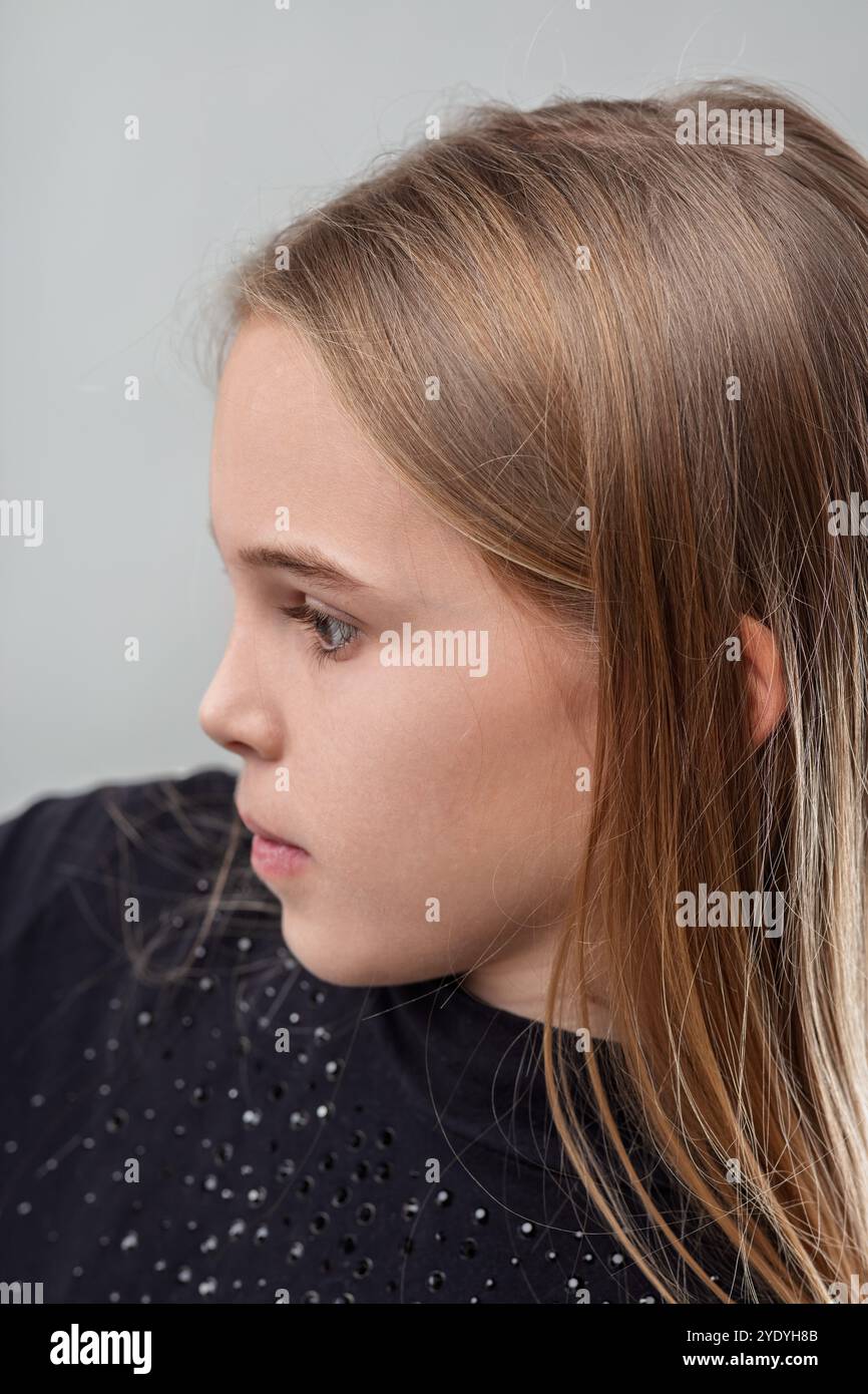 Studio portrait capturing a young girl with long light brown hair ...