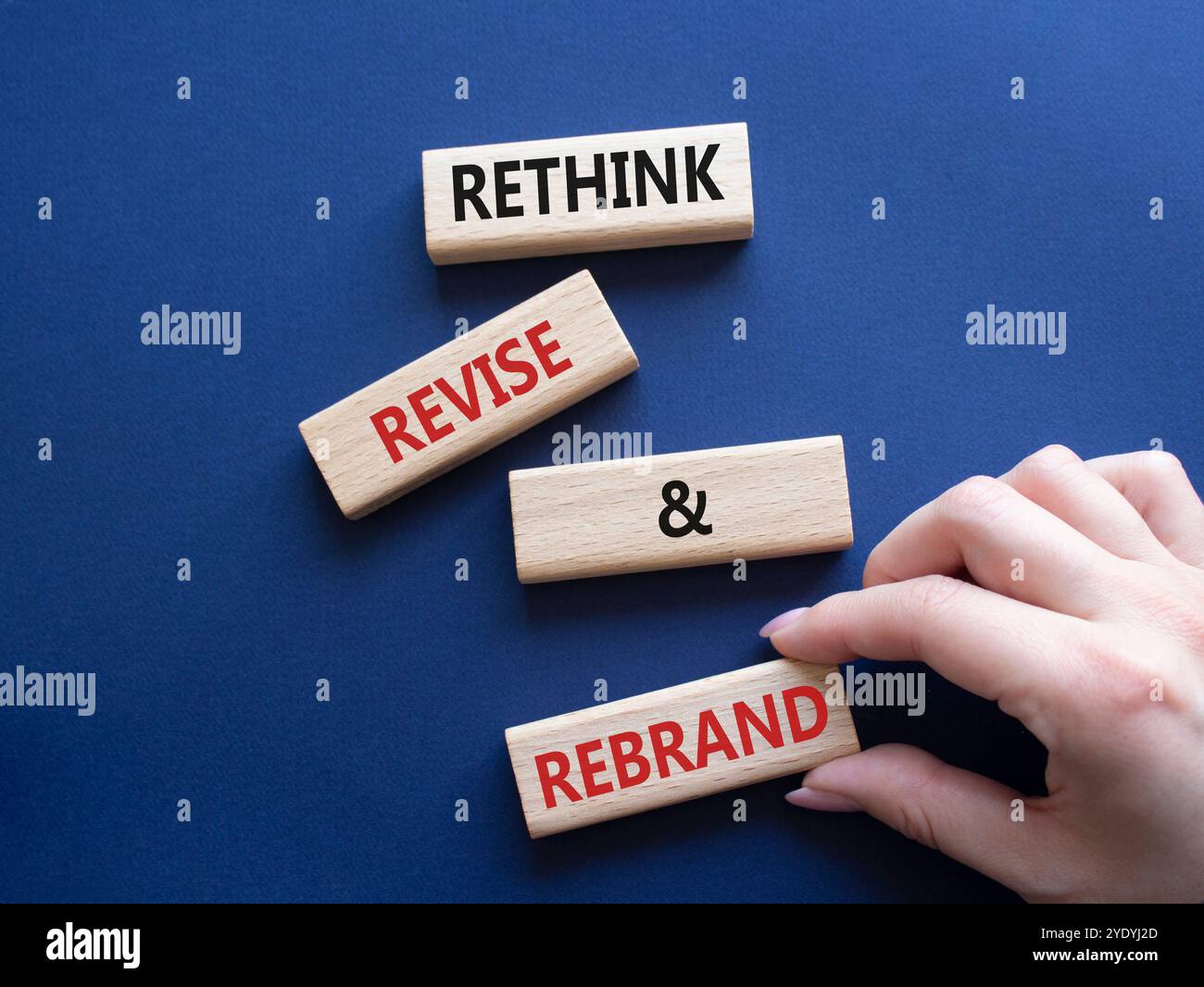 Rethink Revise and Rebrand symbol. Wooden blocks with words Rethink Revise and Rebrand ...
