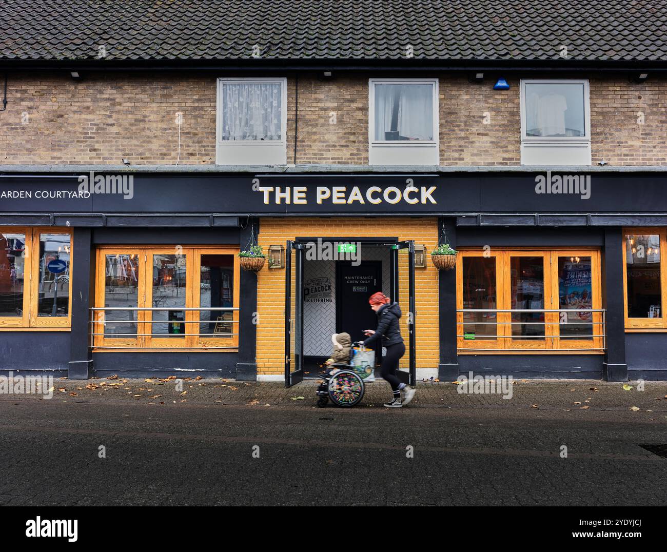 The Peacock pub in the town centre at Kettering, England, on a wet day ...