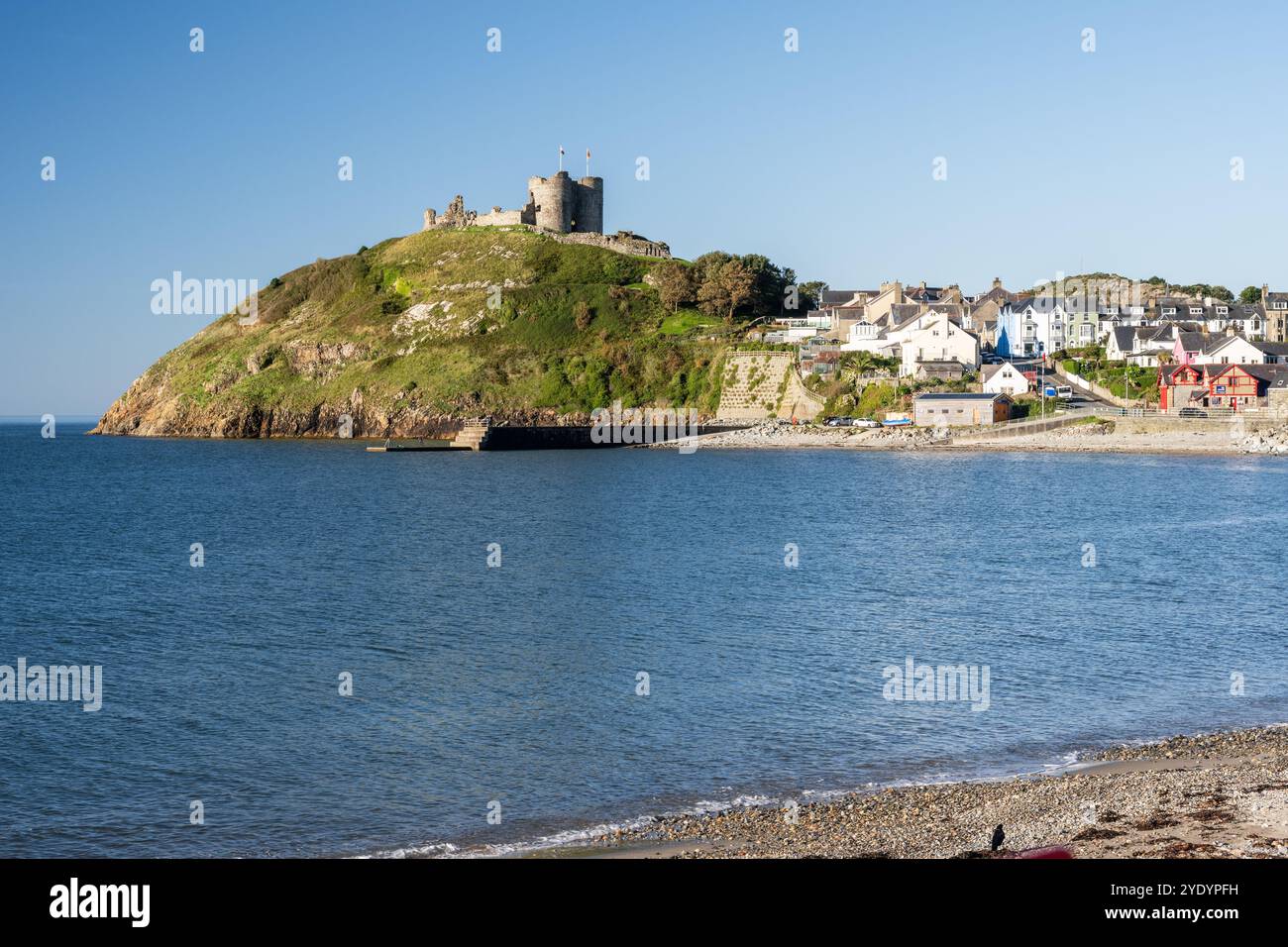 Sun shines on the ruins of Criccieth Castle on the coast of North Wales ...
