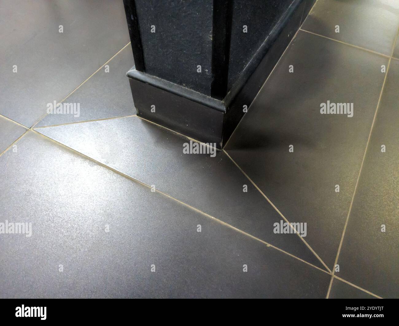 Laying porcelain border on the floor with a trim near the column Stock ...