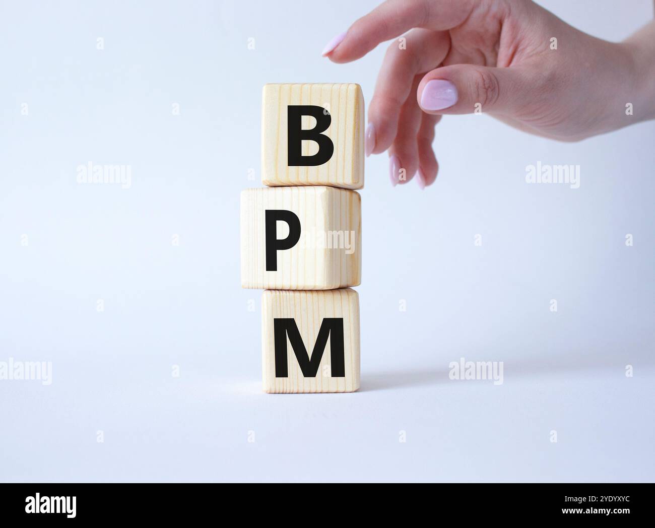 BPM - Business Process Management symbol. Wooden cubes with words BPM ...
