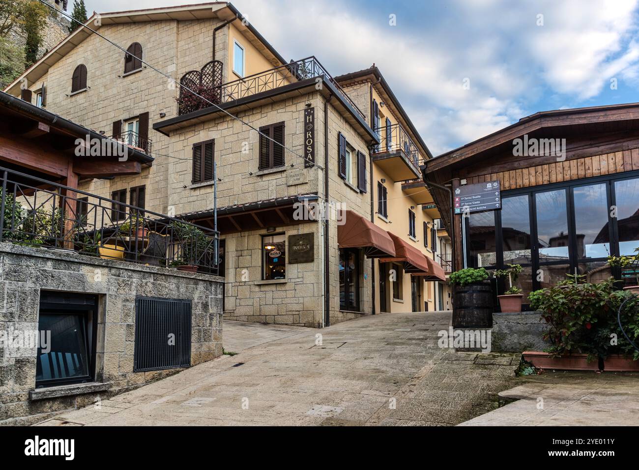 View of a narrow, steep alley in the center of San Marino. The Hotel ...