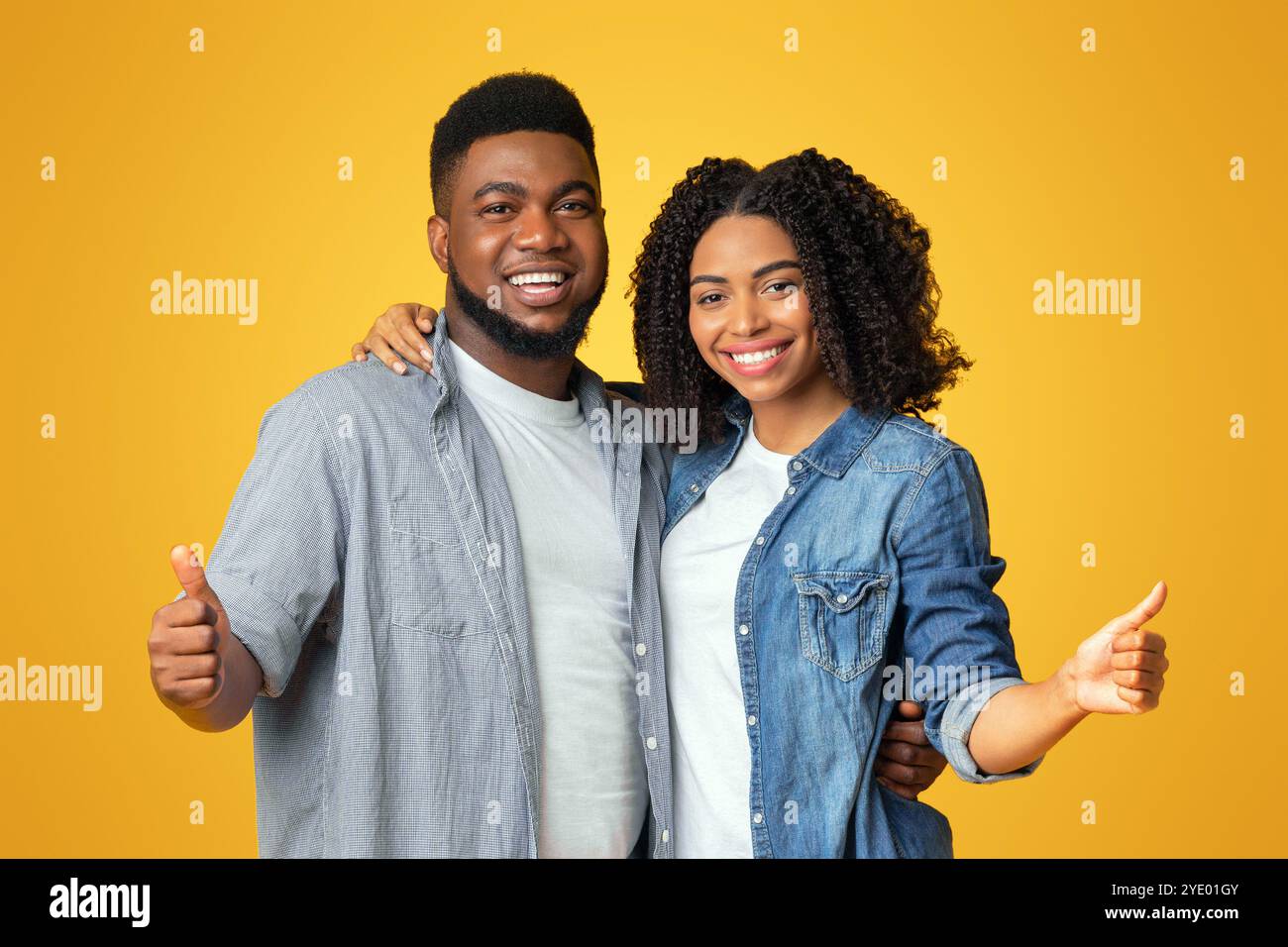 Great choice. Happy african american couple gesturing thumbs up ...