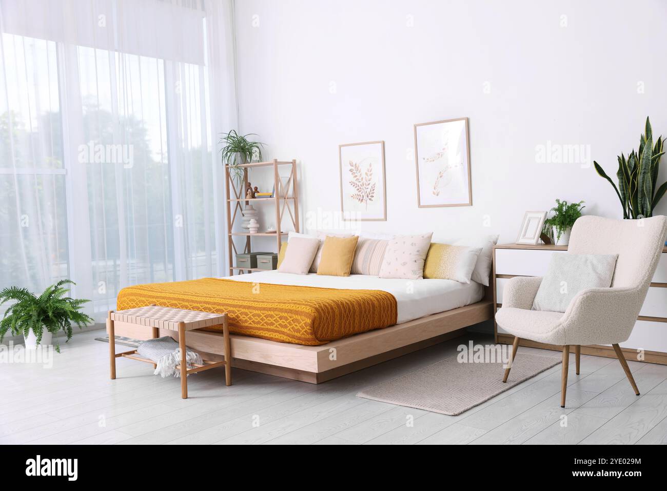 Large bed near window in room. Stylish bedroom interior Stock Photo - Alamy