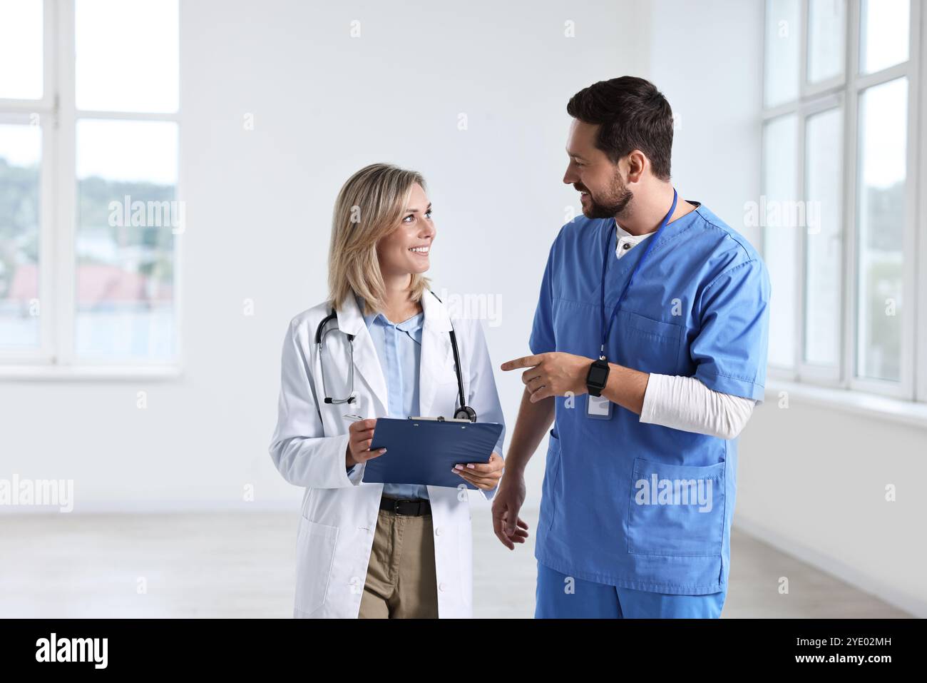 Health care workers colleagues talking hi-res stock photography and ...