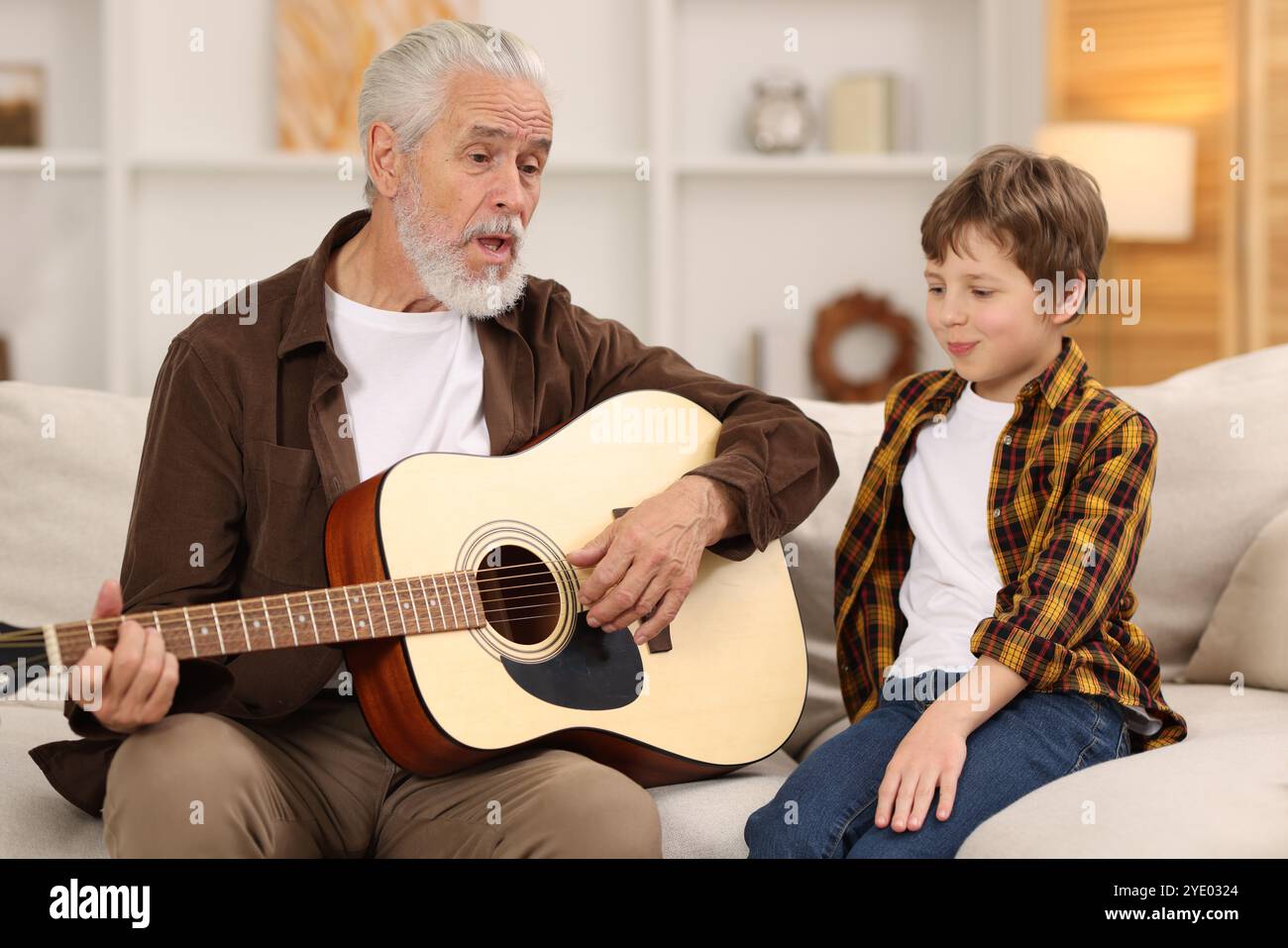 Grandpa teaching grandson play hi-res stock photography and images - Alamy