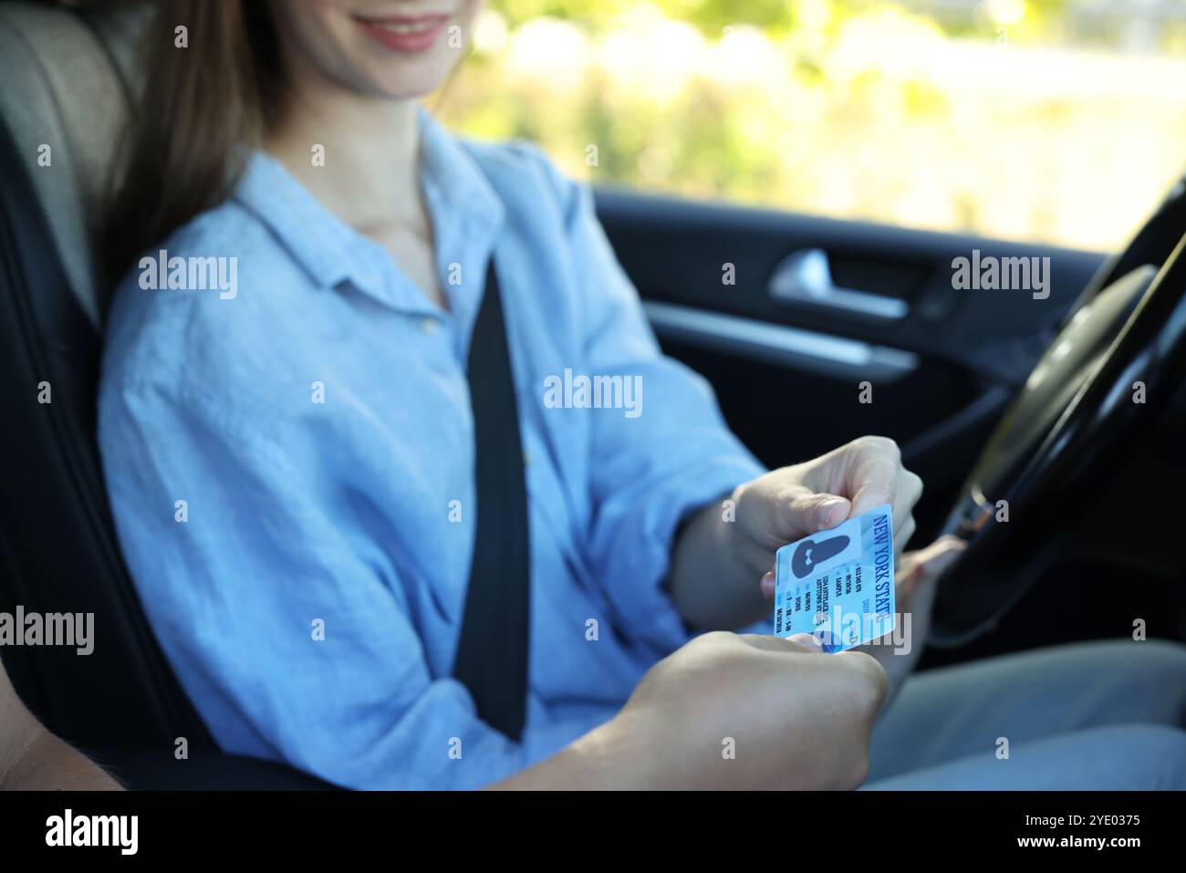 Driving school. Examiner giving driving license to student after exam ...