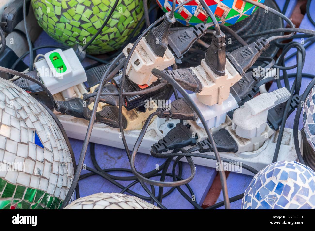 Old and damaged electric adapter power plug has many appliances are ...