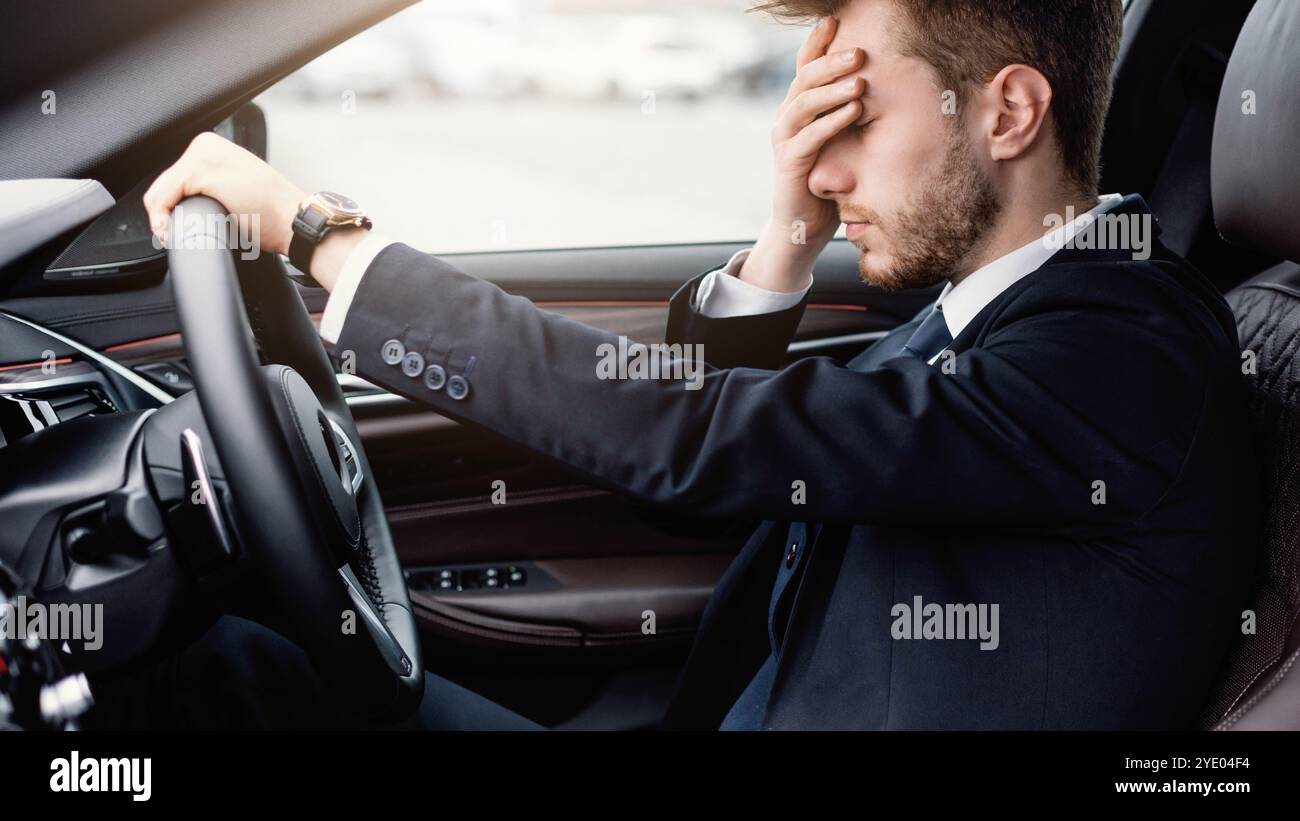 Stressed businessman driving alone in his new car Stock Photo - Alamy