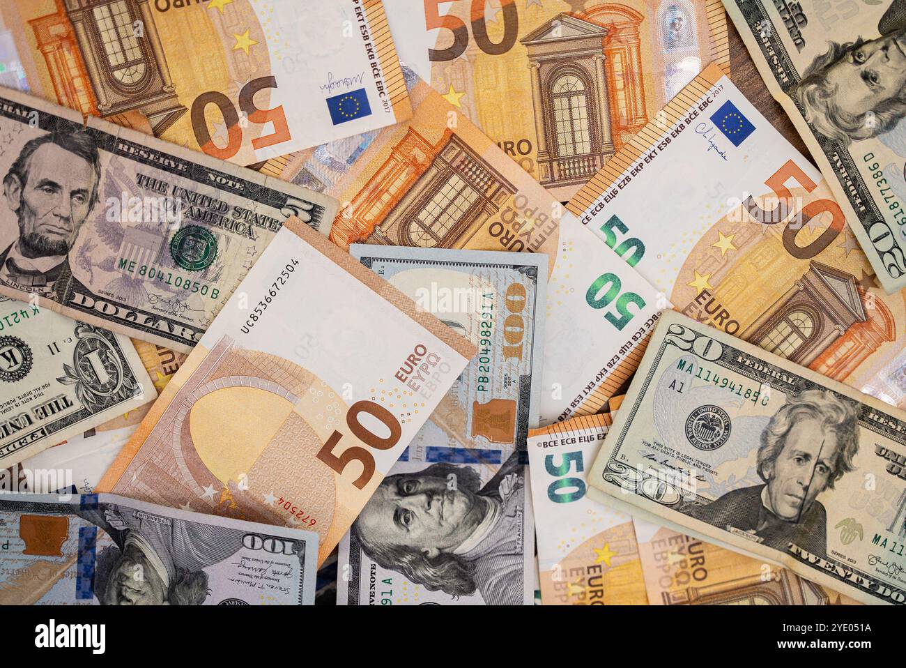 Collection of mixed Euro and US Dollar banknotes spread out. Financial ...