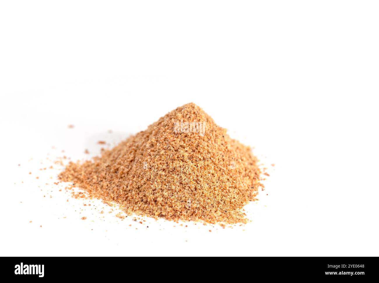 Nutmeg powder against a white background Stock Photo - Alamy