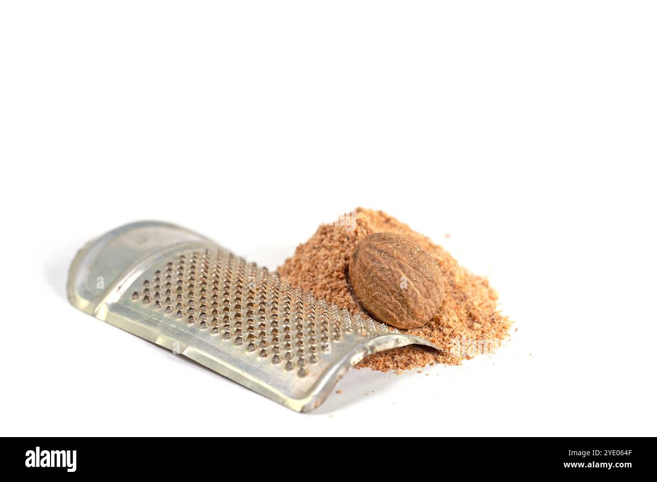 Nutmeg powder and nutmegs against a white background Stock Photo - Alamy