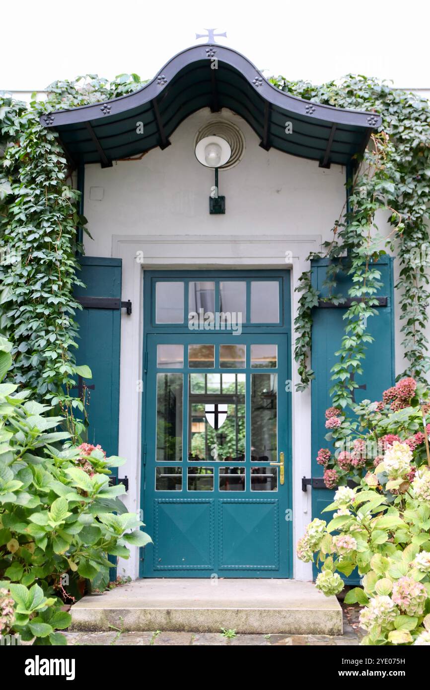 Ivy-Covered Courtyard Entrance Featuring a Decorative Arch, Green ...