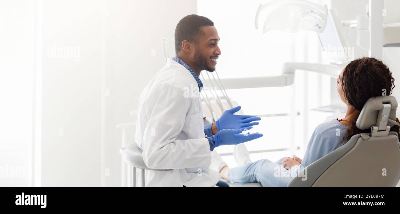 Friendly black dentist explaining patient treatment plan Stock Photo ...