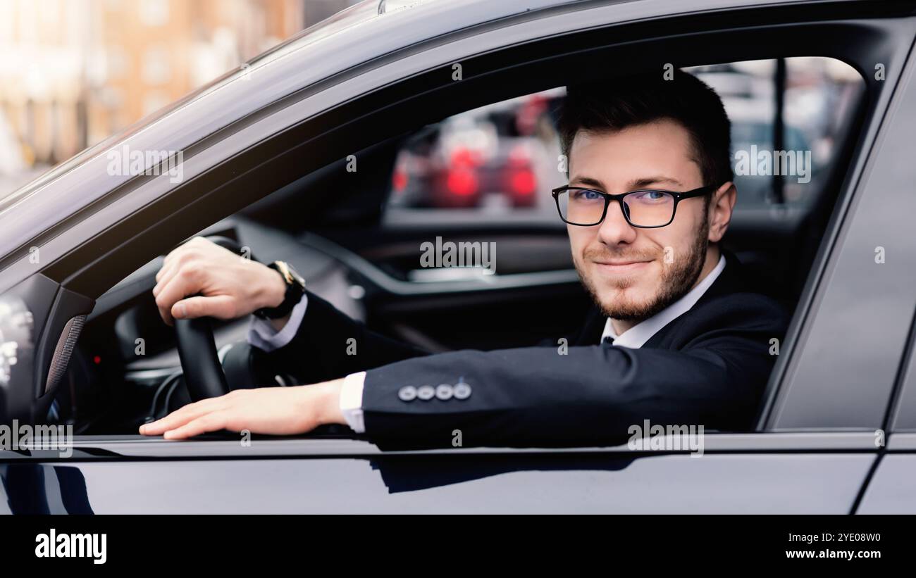 Cheerful business man driving alone in his new car Stock Photo - Alamy